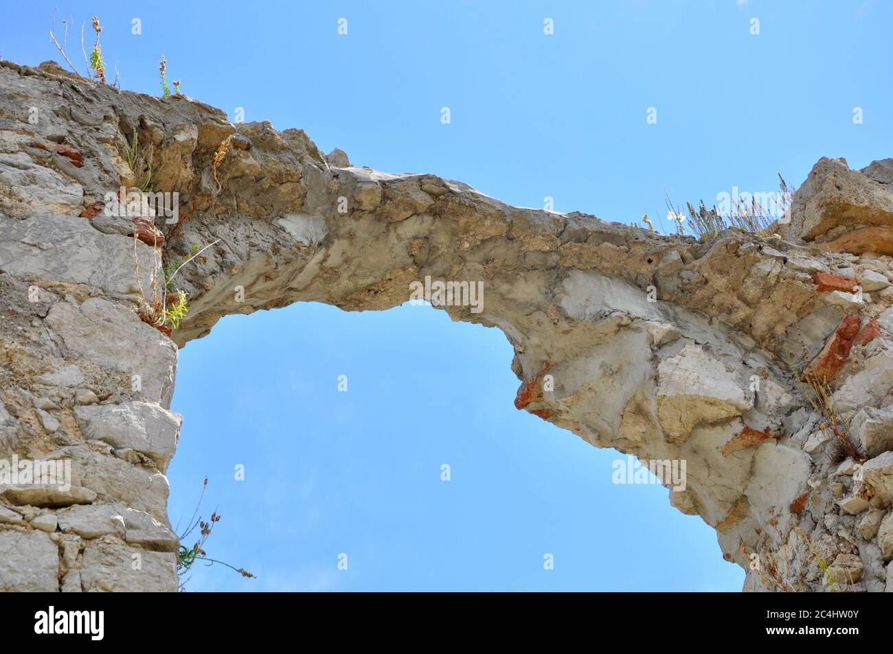 An arch in the ruined wall of the medieval castle Stock Photo - Alamy