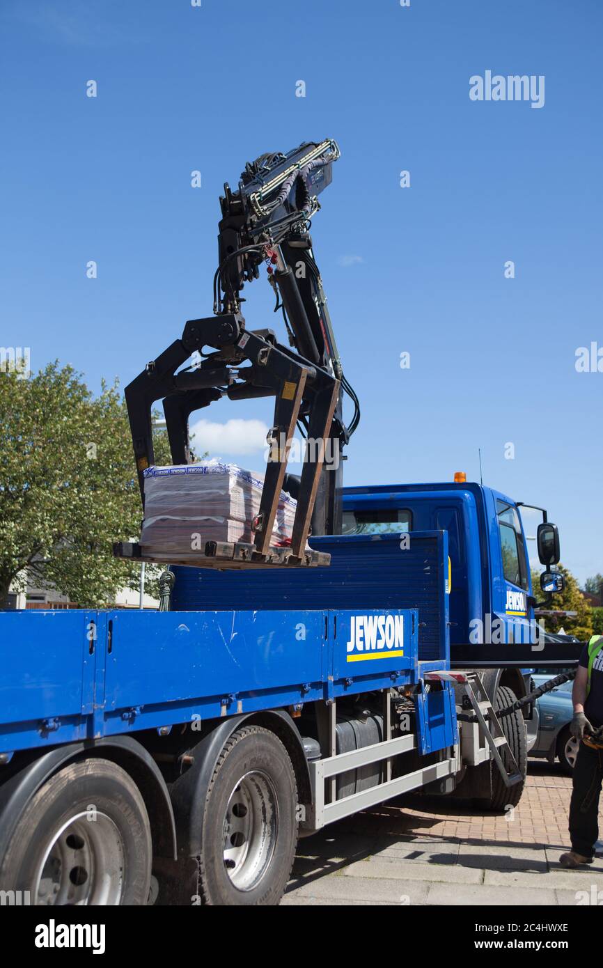Mechanical grab unloading pallett from Lorry. Scotland UK Stock Photo ...