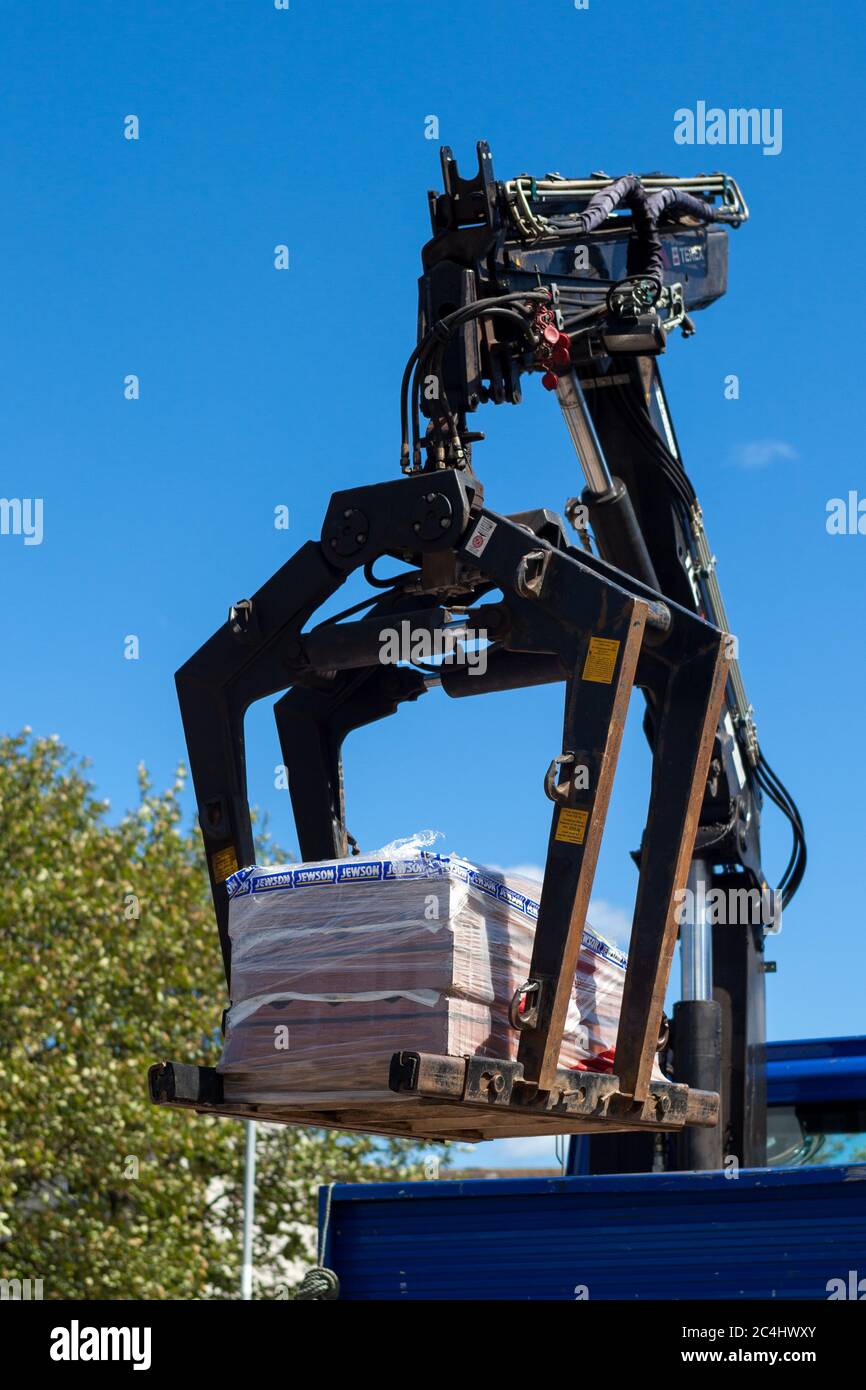 Mechanical grab unloading pallett from Lorry. Scotland UK Stock Photo ...
