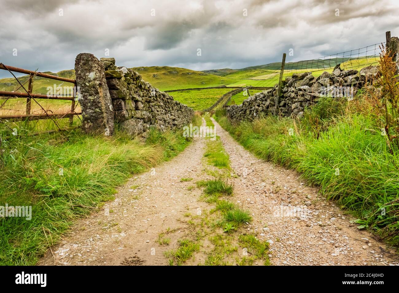 Low level view of a old dirt track leading to a valley in the Yorkshire ...