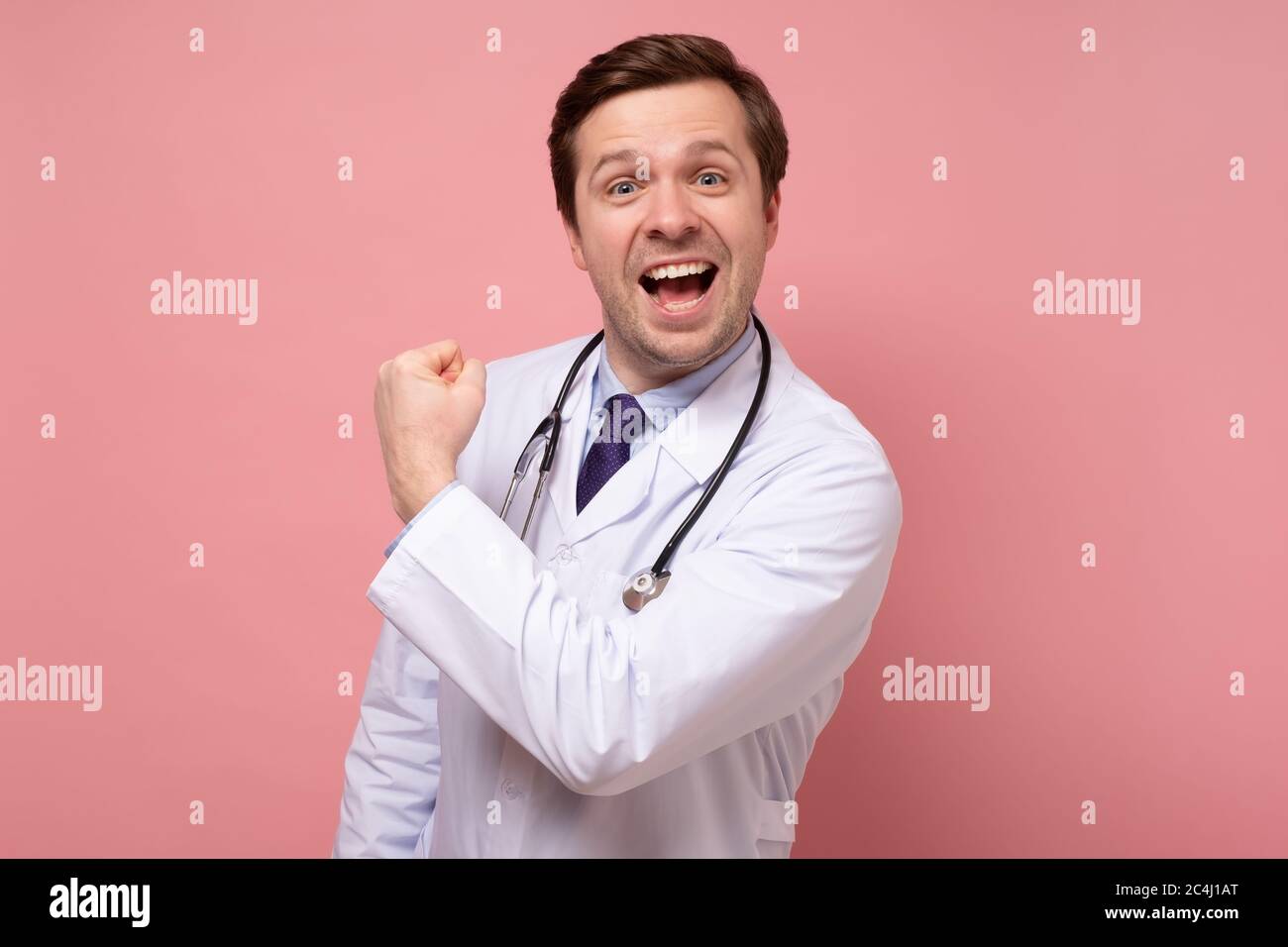 Cheerful doctor raising hands hi-res stock photography and images - Alamy