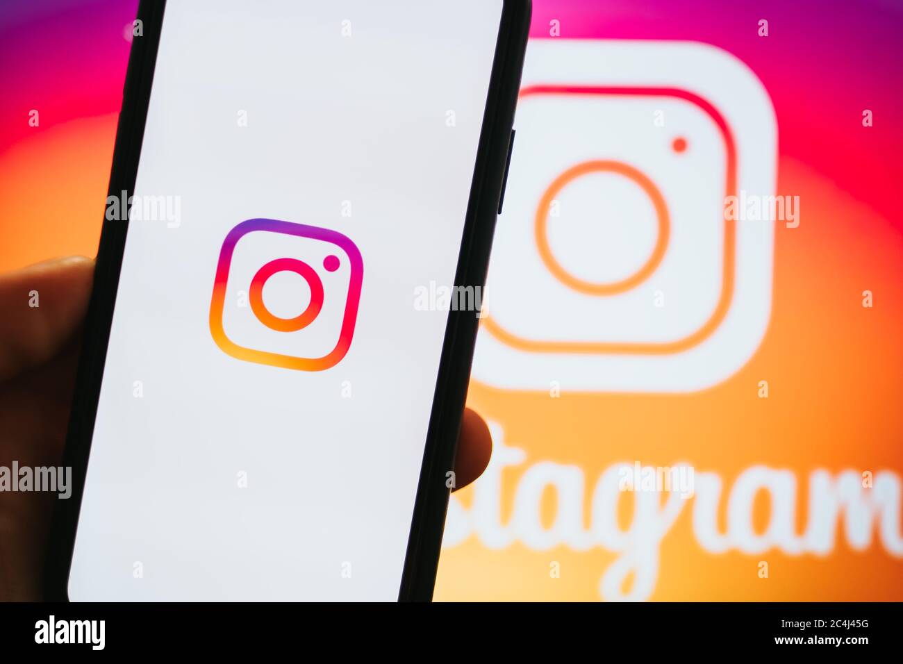 hands holding the iPhone with instagram app on the screen Stock Photo ...