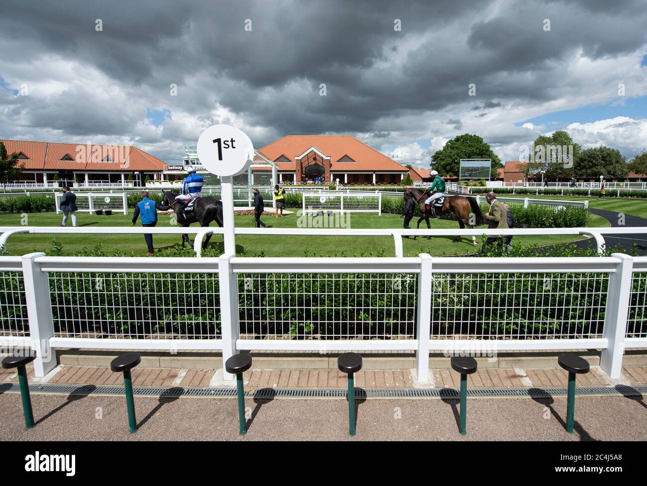 Limato and jockey Adam Kirby (right) are led into the winners enclosure ...