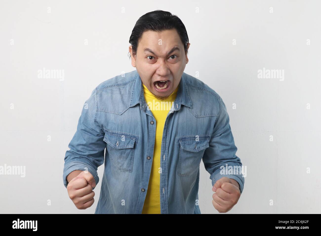 Young Asian man shouting loud because of anger. Close up head and ...