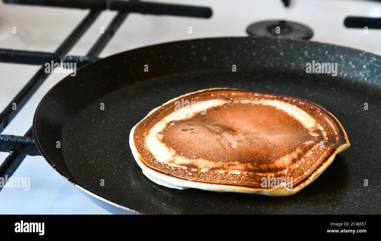 pancake burn on the pan, homemade pancake fried in a pan in the kitchen ...