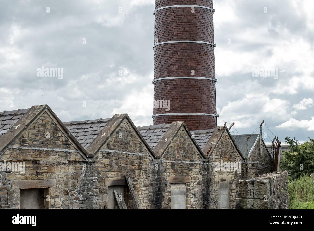 Old-style mill factory showing the individual roof structures. A large ...