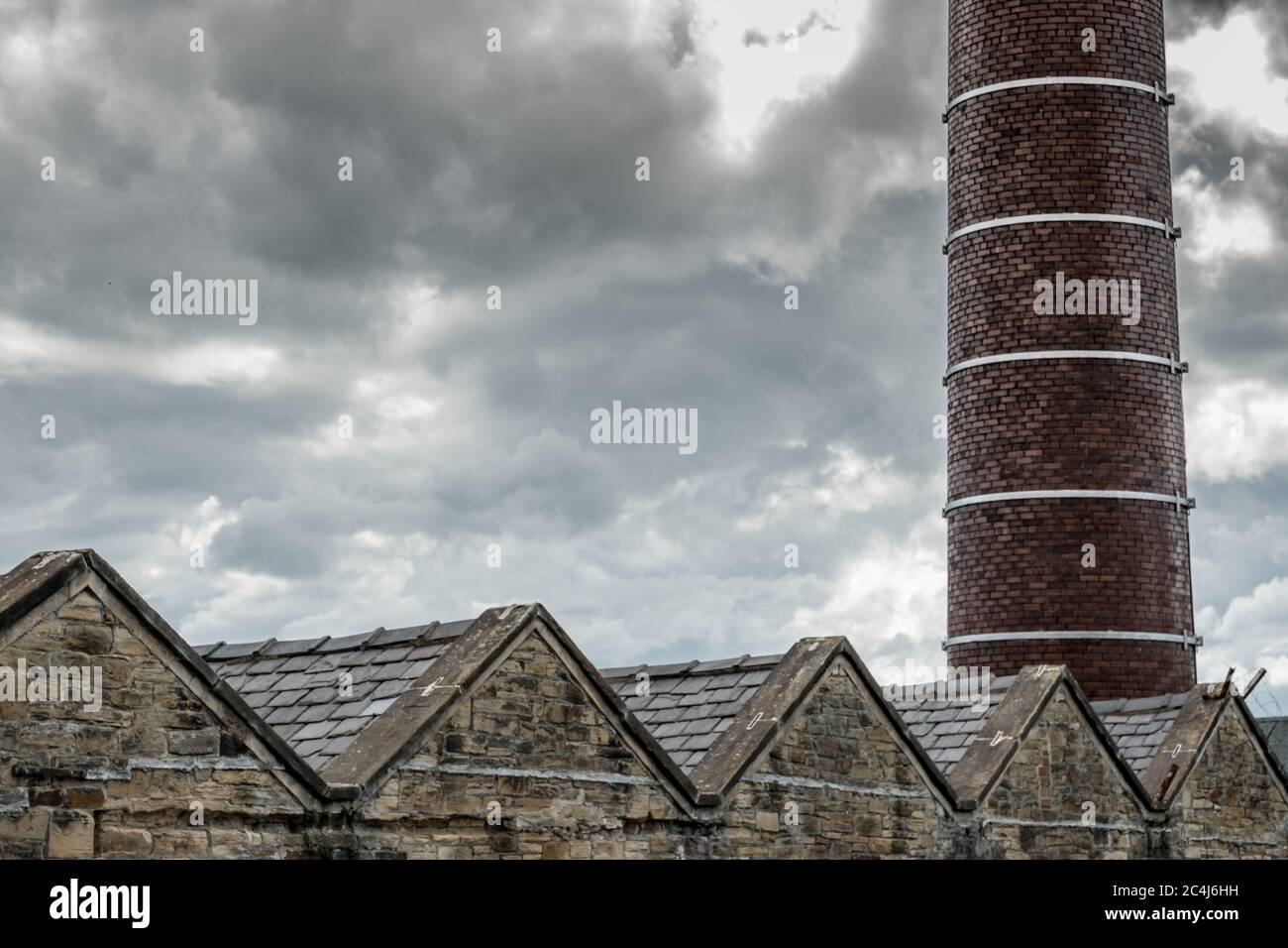 Old-style mill factory showing the individual roof structures. A large ...
