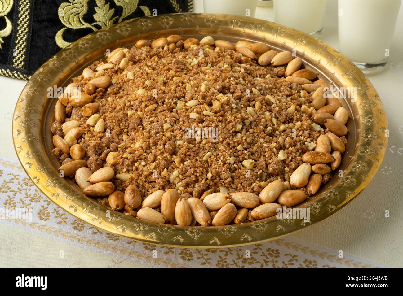 Traditional Moroccan homemade sellou on a metal dish and milk close up ...