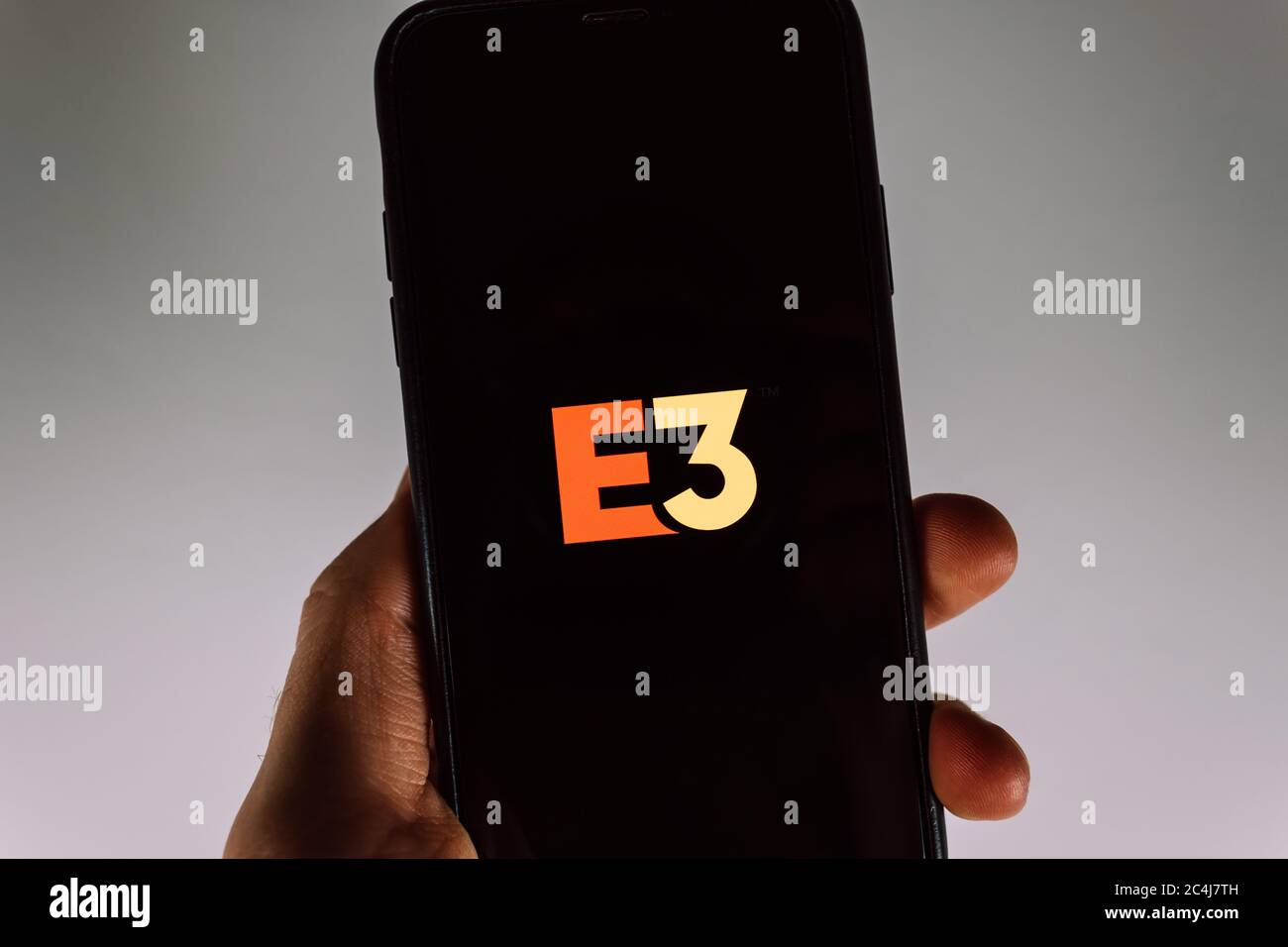 Hand holds smartphone with e3 logo on screen Stock Photo - Alamy