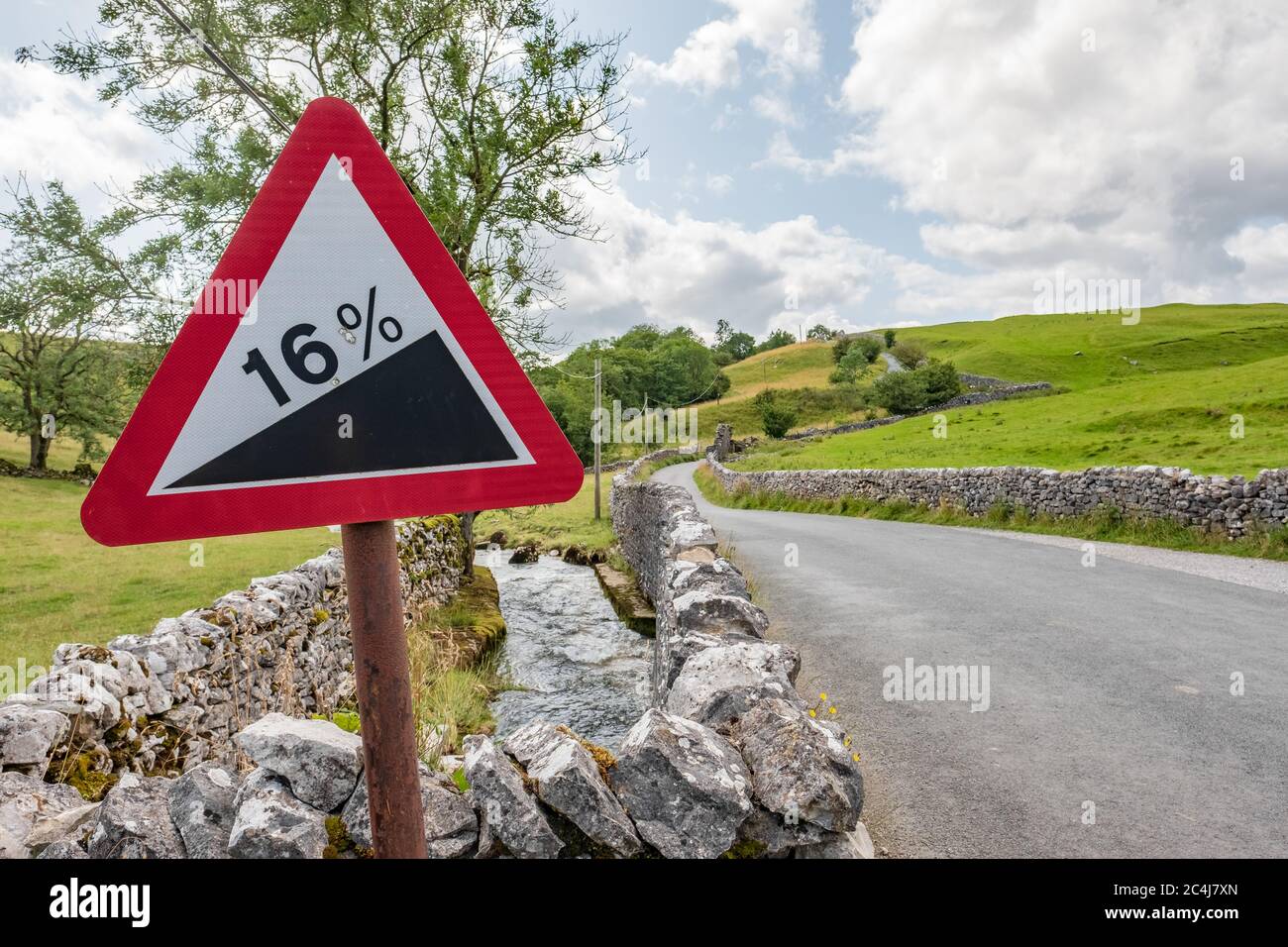 Detailed view of a red warning roadside triangle showing a 16% steep ...