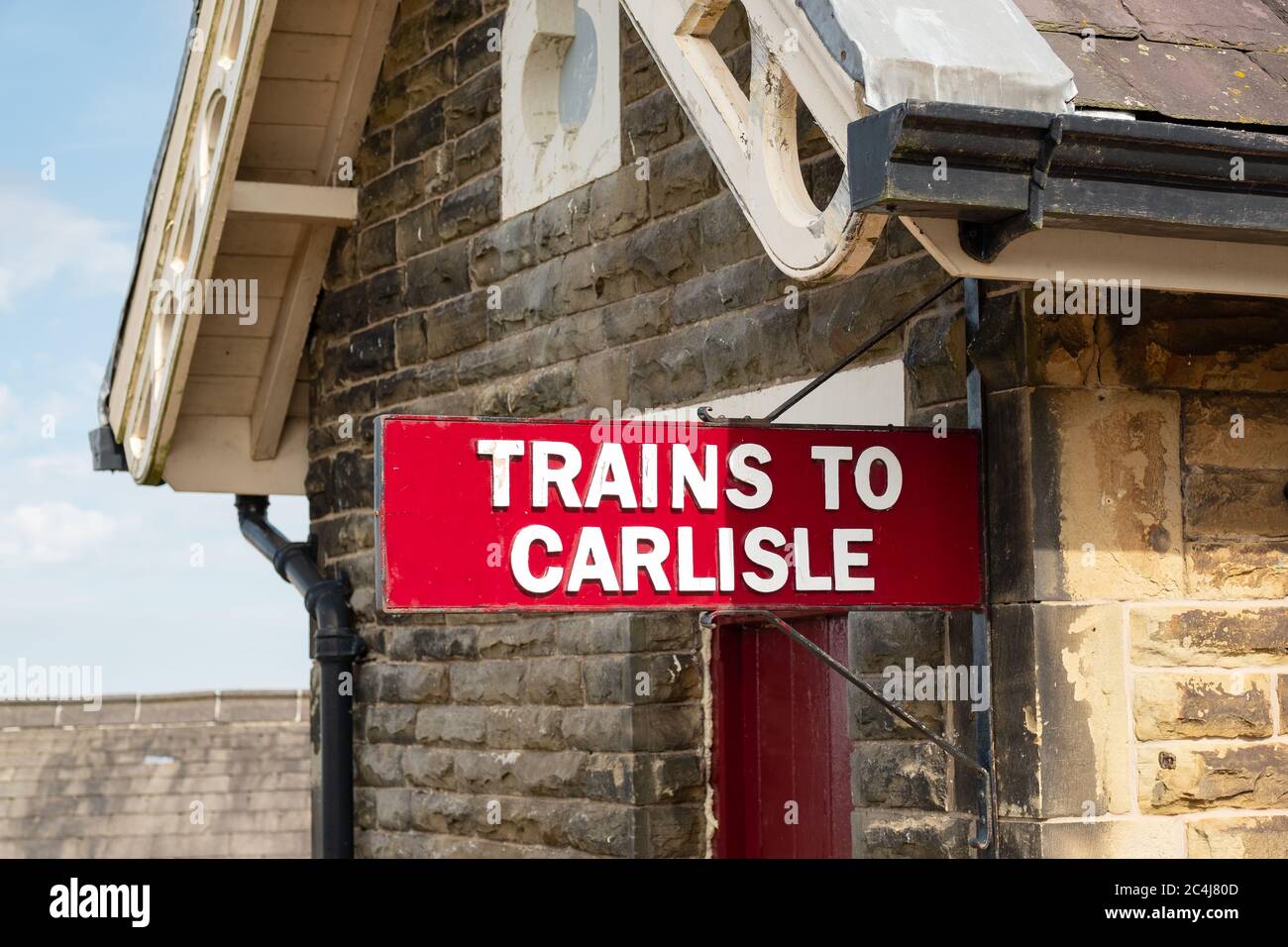 View of a newly painted, vintage metal sign seen on a railway platform ...