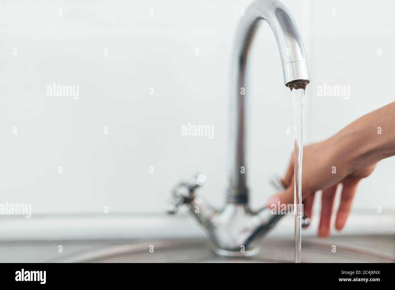 Female hand opening water tap hi-res stock photography and images - Alamy