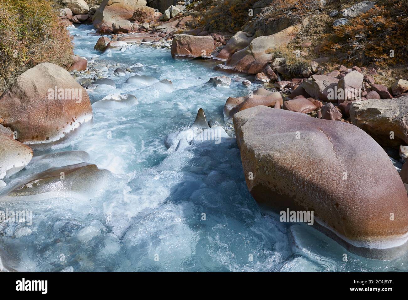Ice cold river from the Paloma glacier running through autumn coloured ...