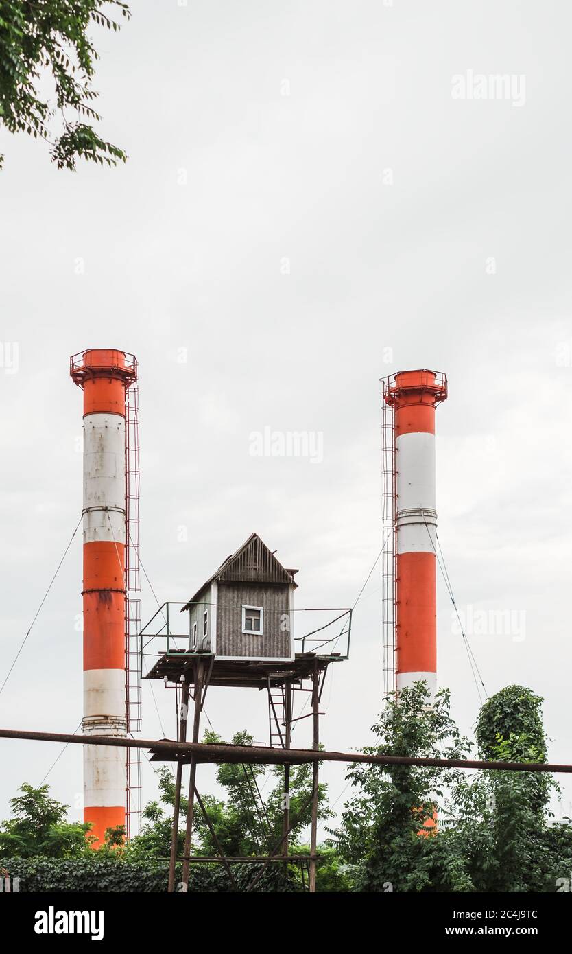 Industrial factory pipe and small house for children Stock Photo - Alamy