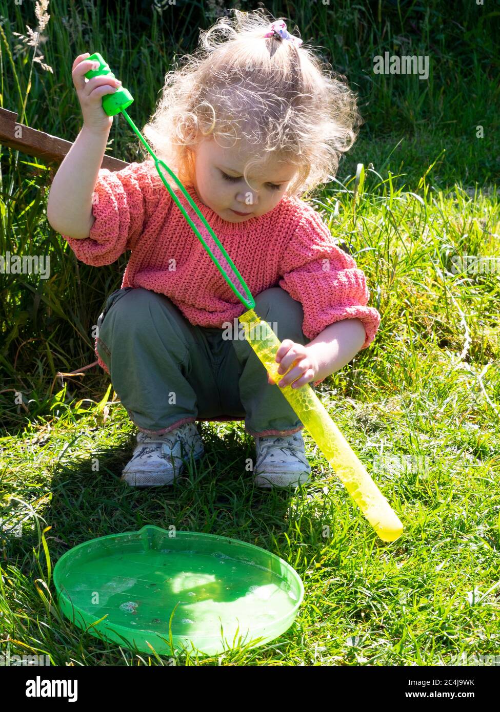 Toddler playing outside, UK Stock Photo - Alamy