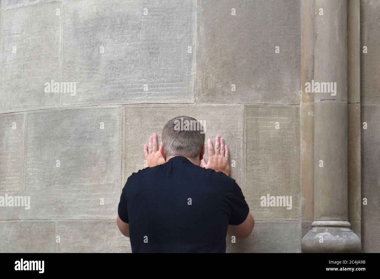 The guy with reverence touches the sacred old wall Stock Photo - Alamy