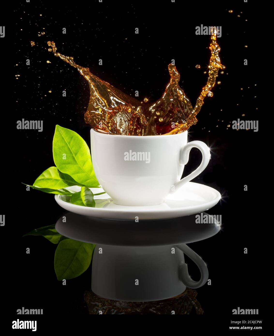 coffee cup splashing isolated on black background Stock Photo - Alamy