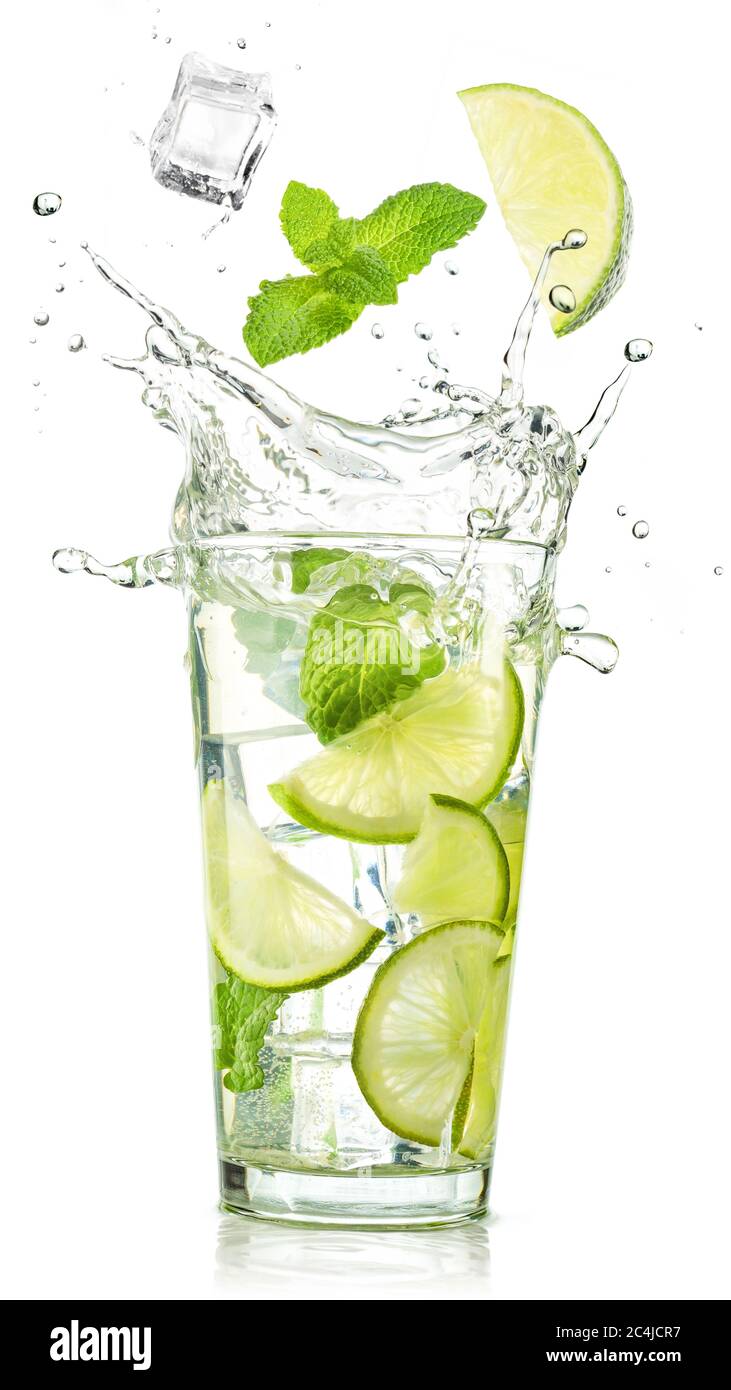 lime and mint falling into a cocktail splashing on white background ...
