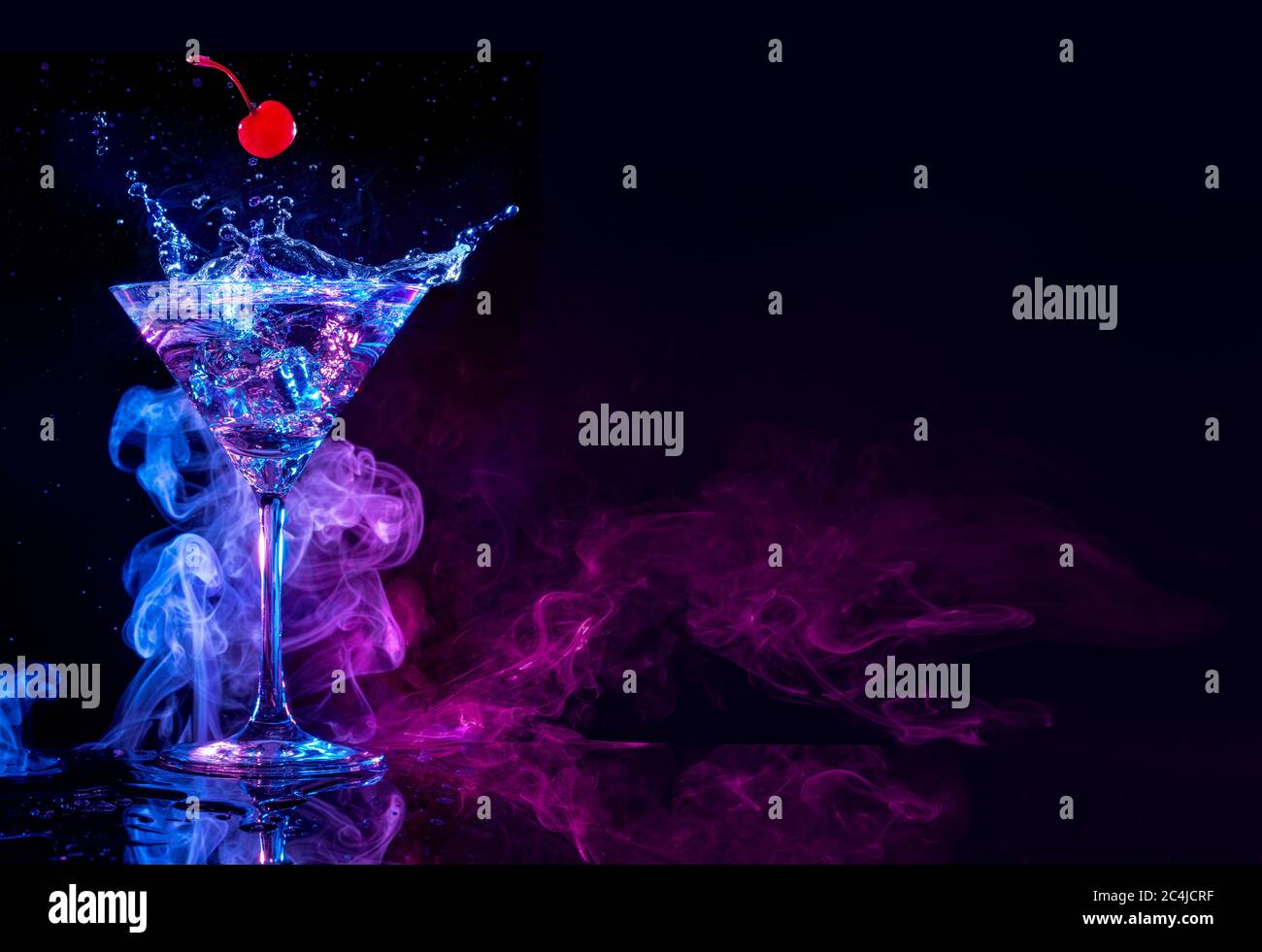 cherry falling into a martini cocktail splash on blue and purple smoky ...