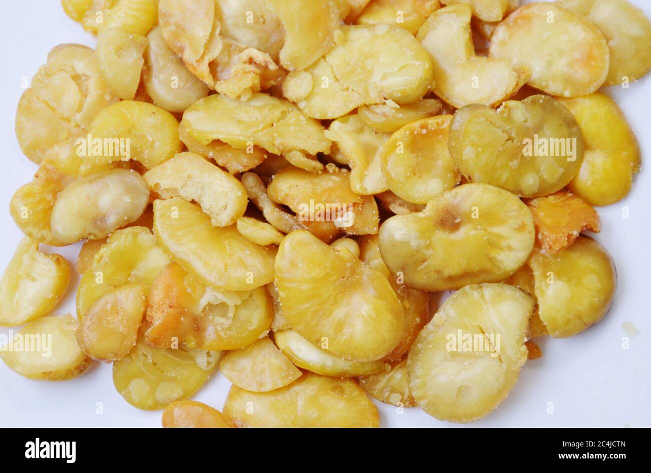 baked salt broad beans on white background Stock Photo - Alamy