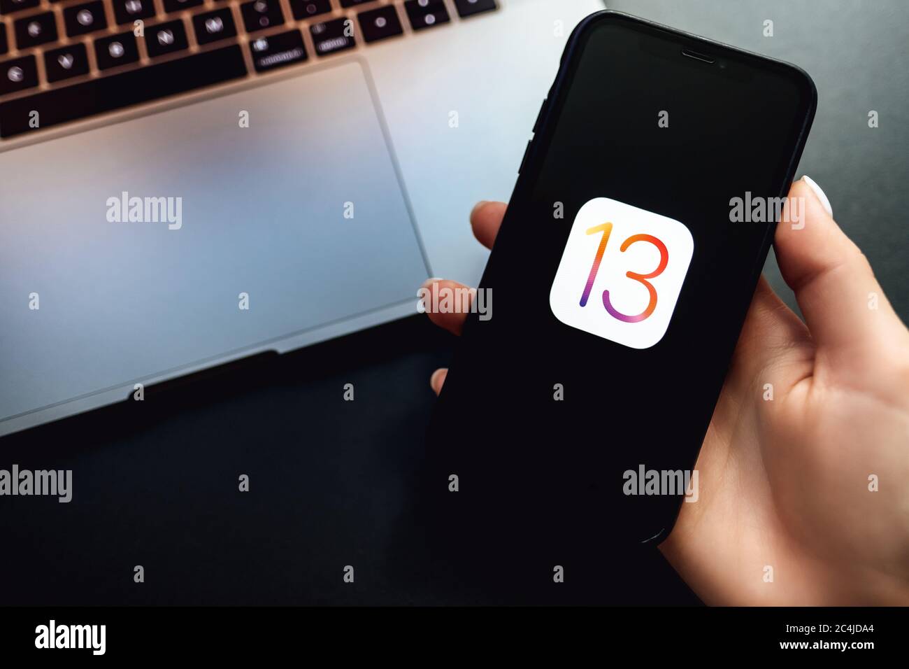iPhone and MacBook with iOS 13 logo on the screen Stock Photo - Alamy