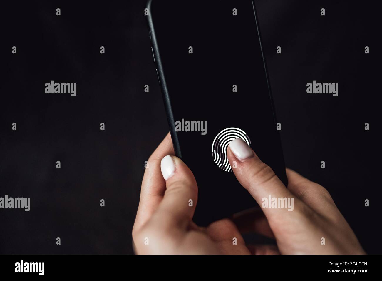 Hands holding smartphone with fingerprint scanner in the screen Stock ...