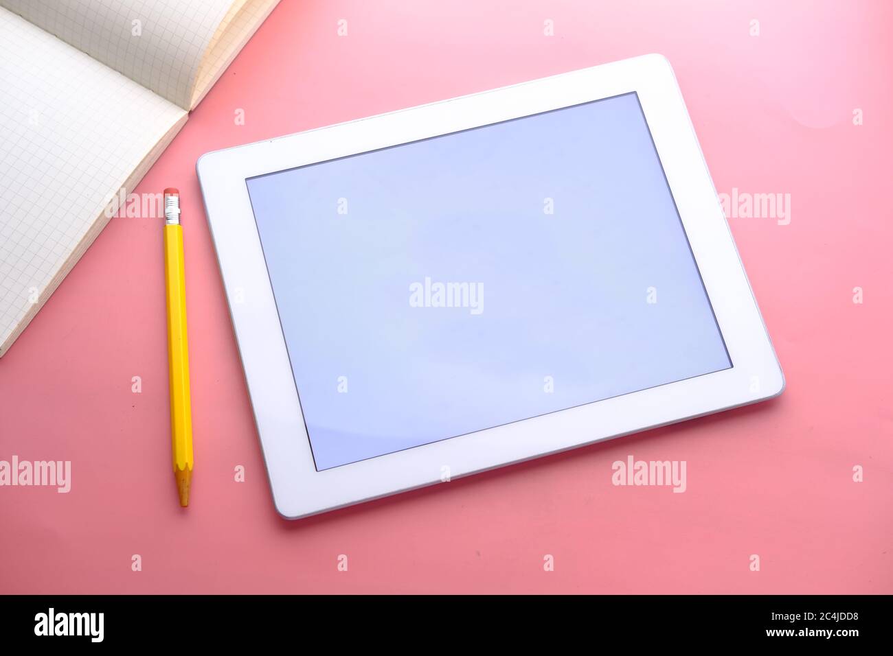 Flat composition of digital tablet and notepad on pink background Stock ...