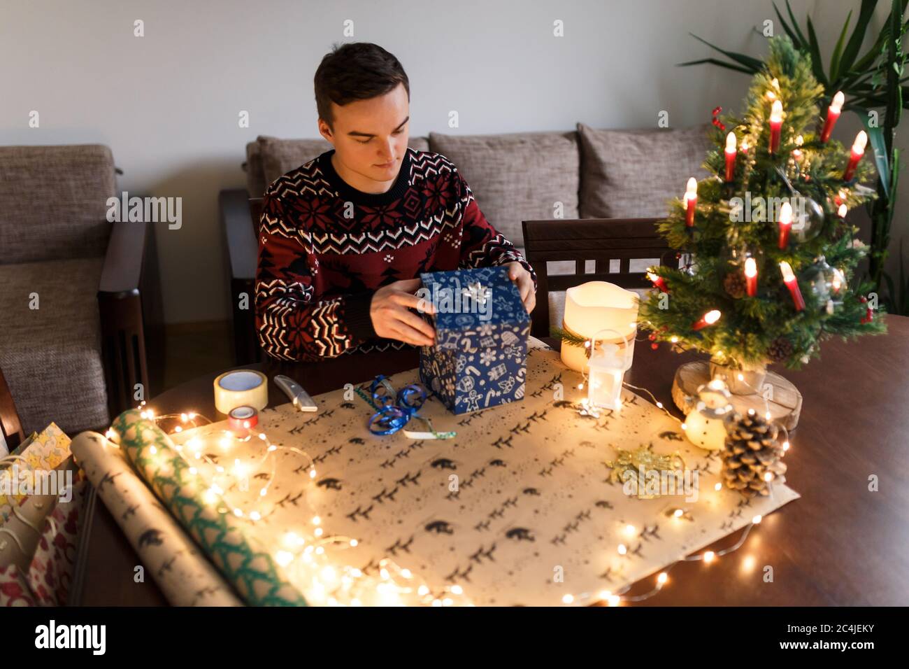Young man packs christmas hi-res stock photography and images - Alamy