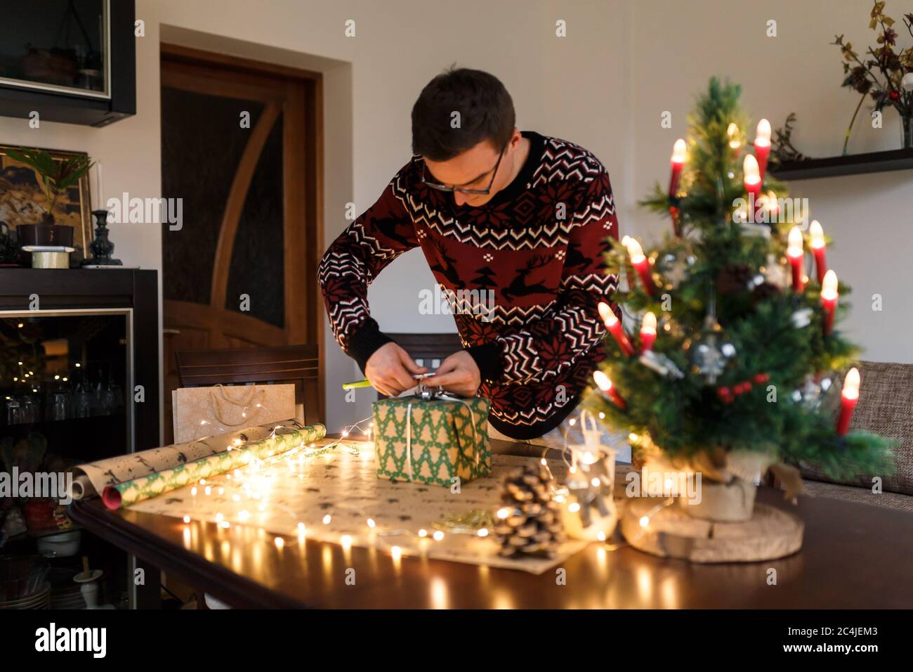 Young man packs christmas hi-res stock photography and images - Alamy