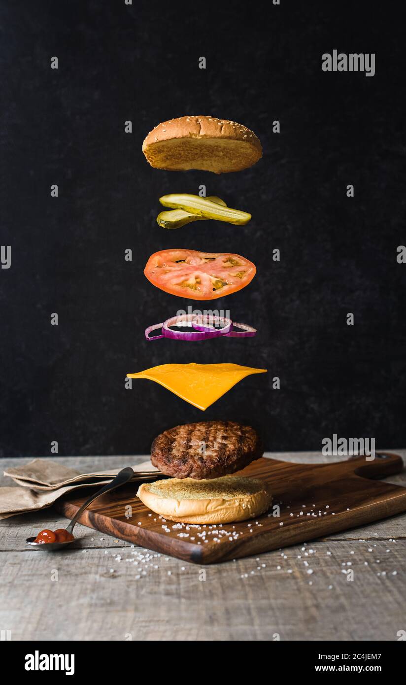 Burger with separated floating ingredients on black background Stock ...
