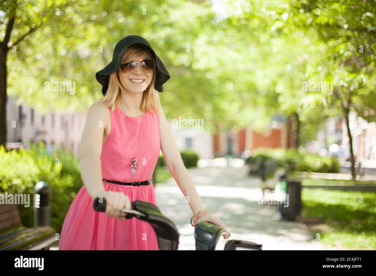 Woman riding bicycle in city dress hi-res stock photography and images ...