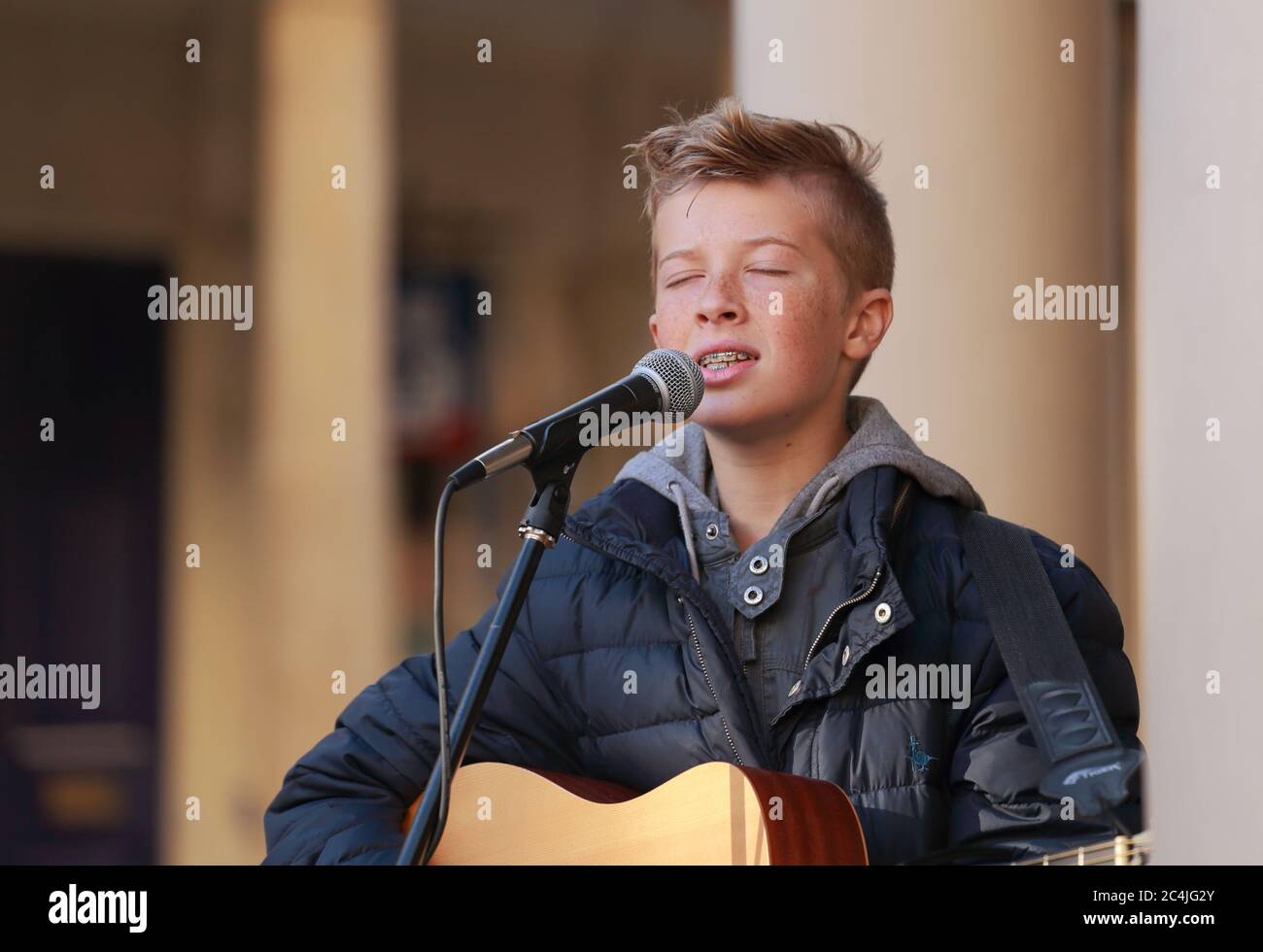 Image of a young busker boy in the Stall Street , Bath, England, 04.11. ...