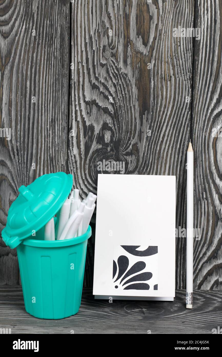 Notebook and pencil box in the form of a garbage container with white ...