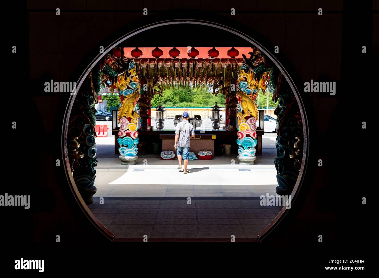 Miri, Sarawak, Malaysia: A man in front of one of the altars of Taoist ...