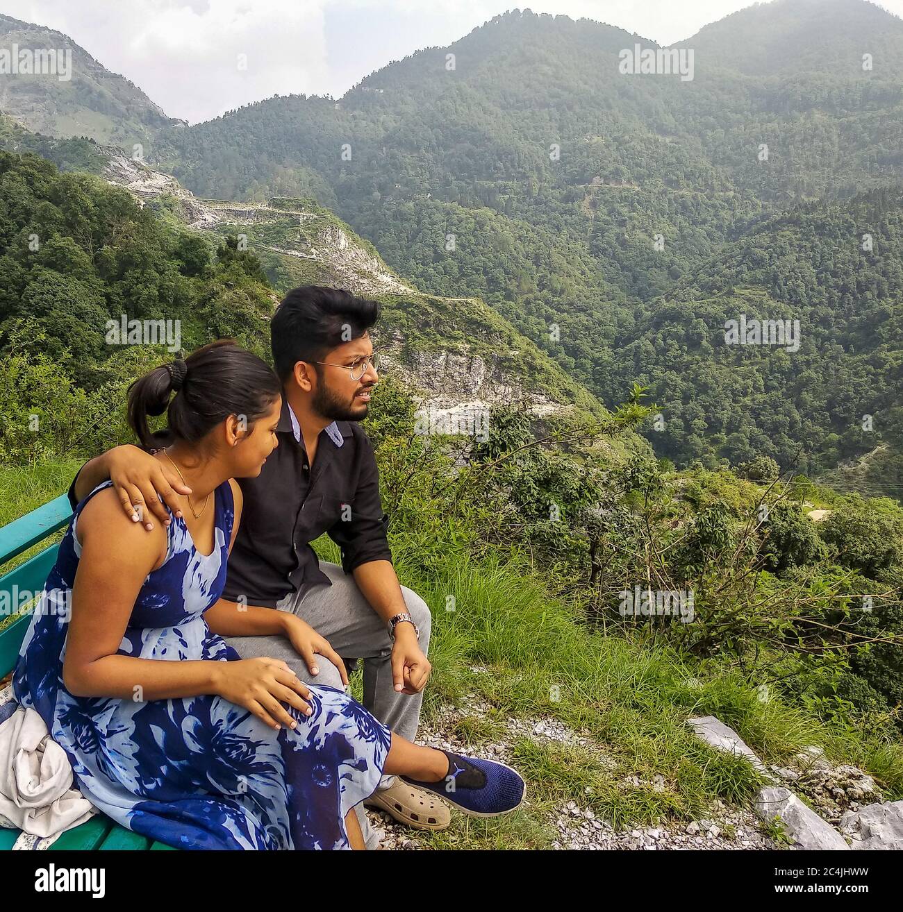 Mussoorie, Uttarakhand, India; 21-Jul-2019; couple sitting on a bench ...