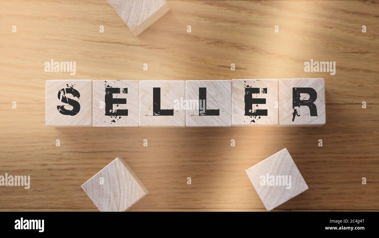 Seller, word cube with background. Business concept Stock Photo - Alamy