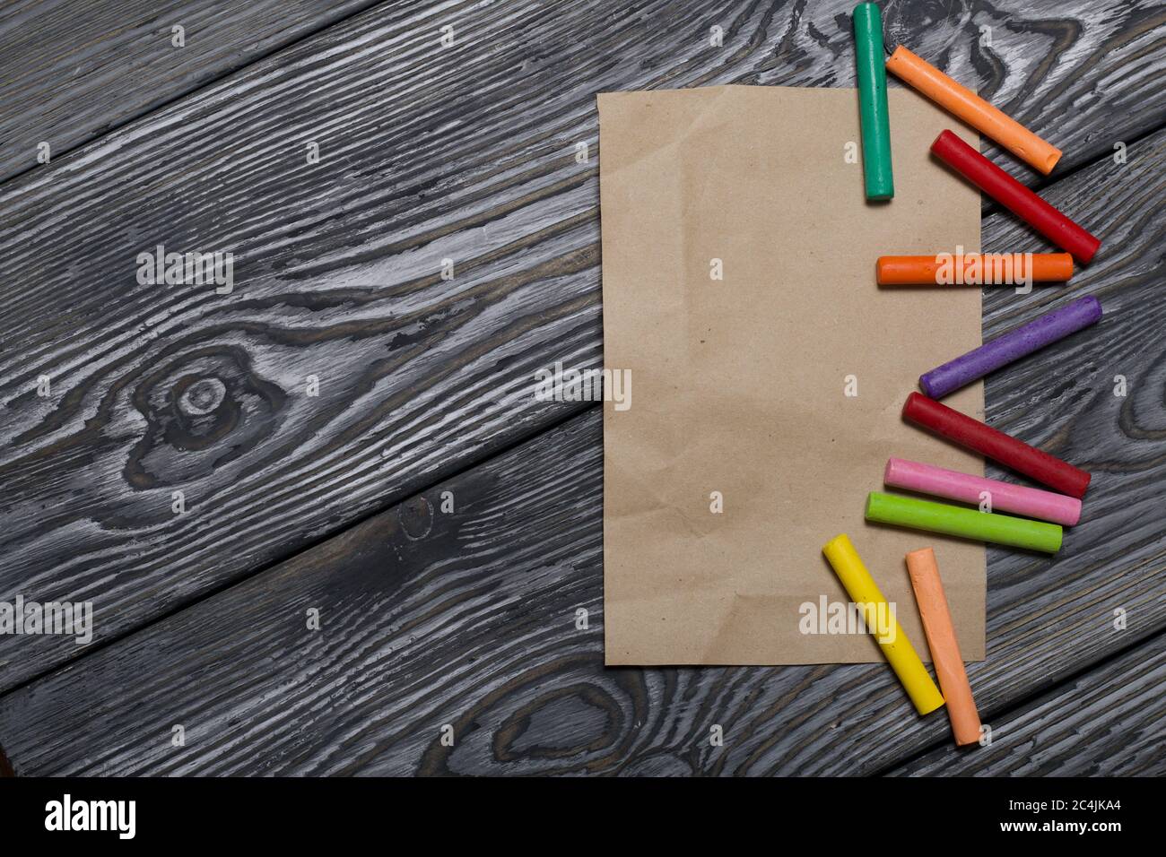 Pastel for drawing and a sheet of paper. Sticks of different colors ...