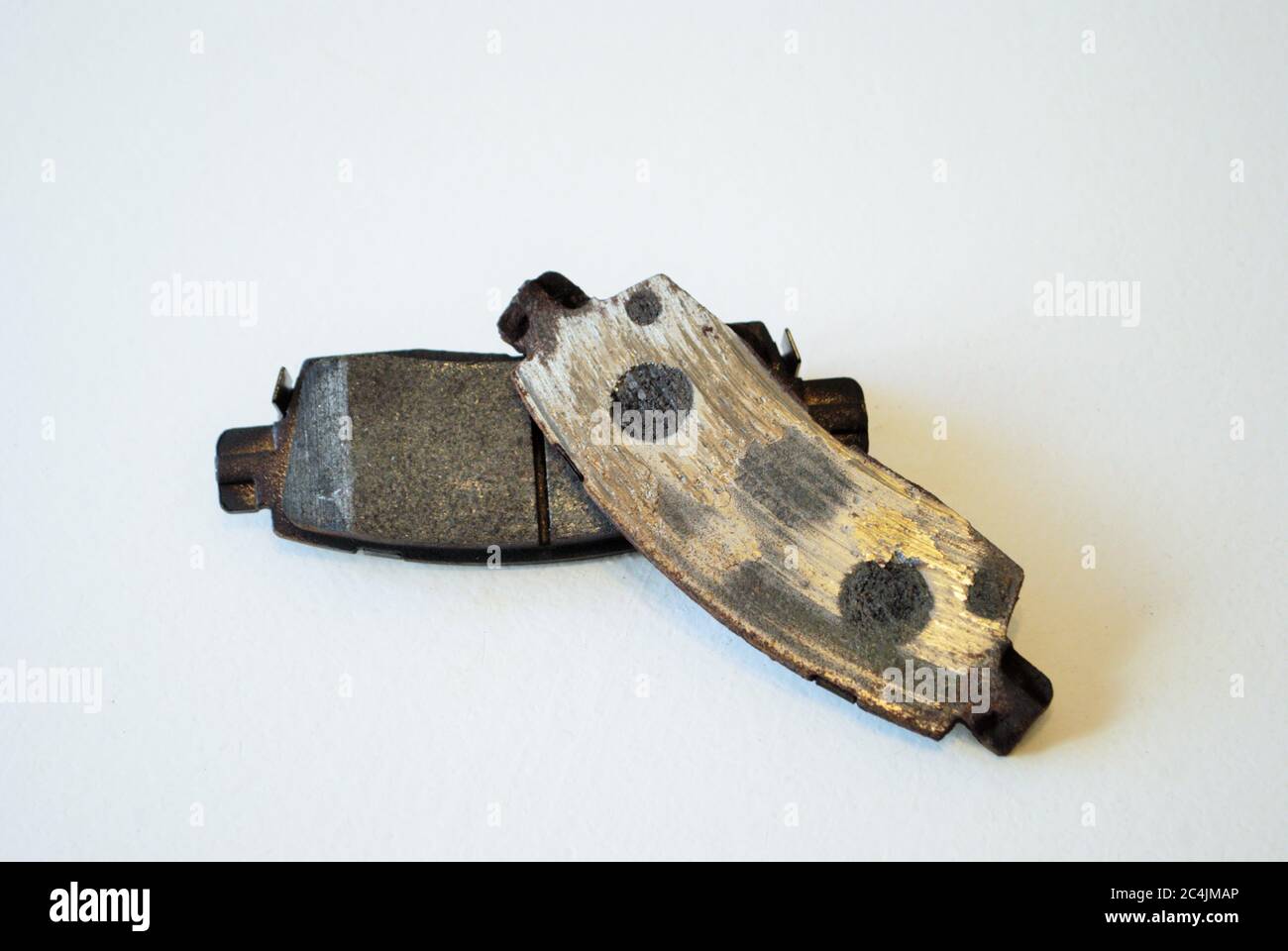 Worn out ruined disc brake pad compared to one that is new Stock Photo ...