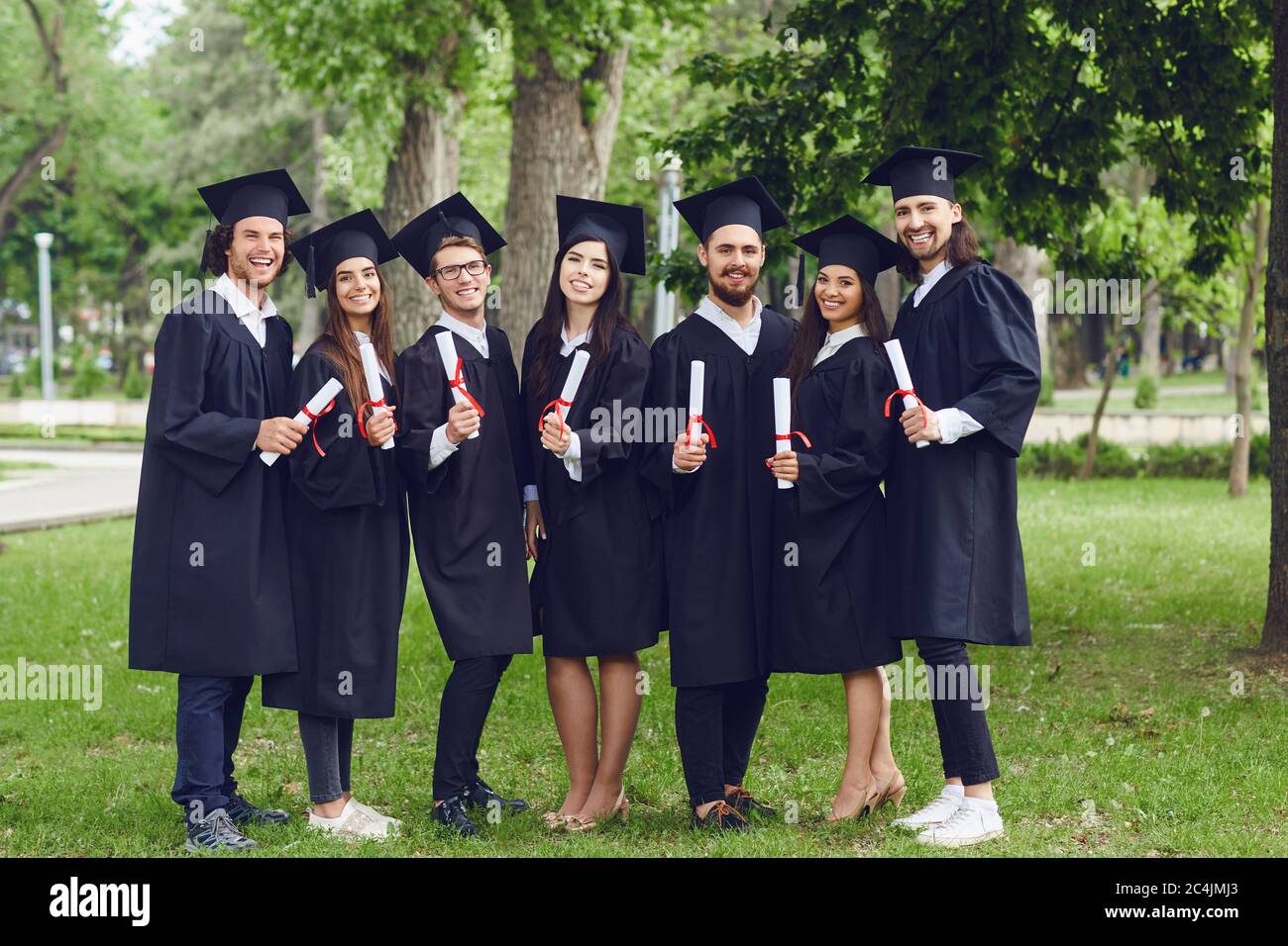 A group of graduates smiling Stock Photo - Alamy
