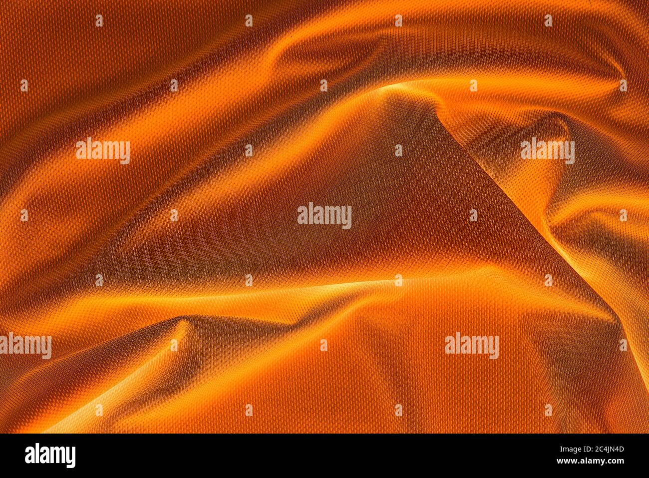 Golden fabric, cloth as wave background Stock Photo - Alamy