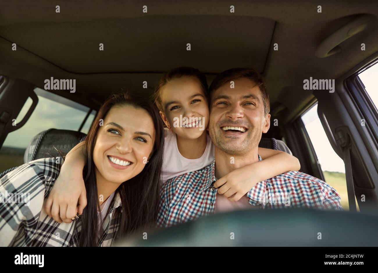 Happy family travels by car in summer. Adorable girl embracing her ...
