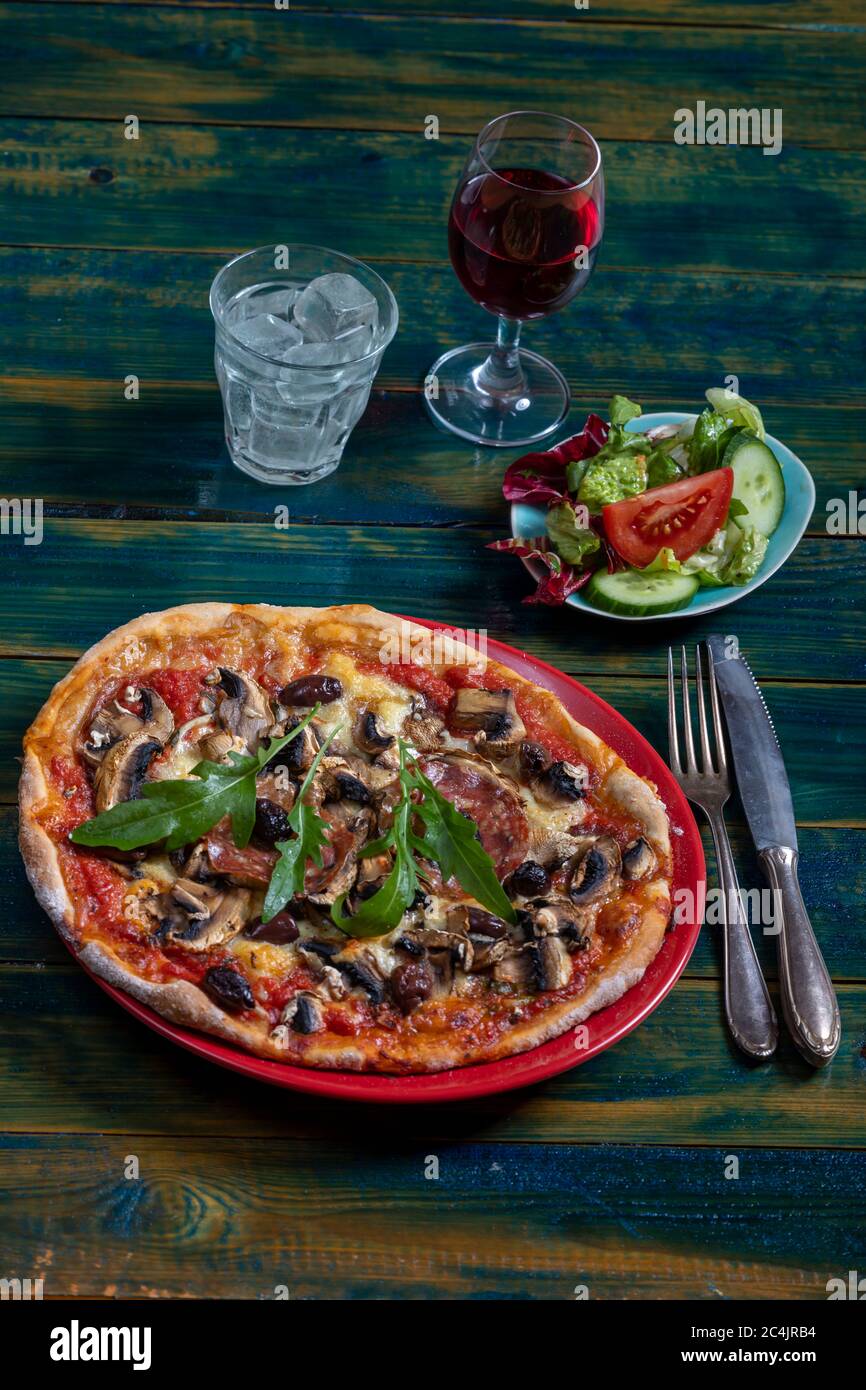 overview of a pizza with salad Stock Photo - Alamy