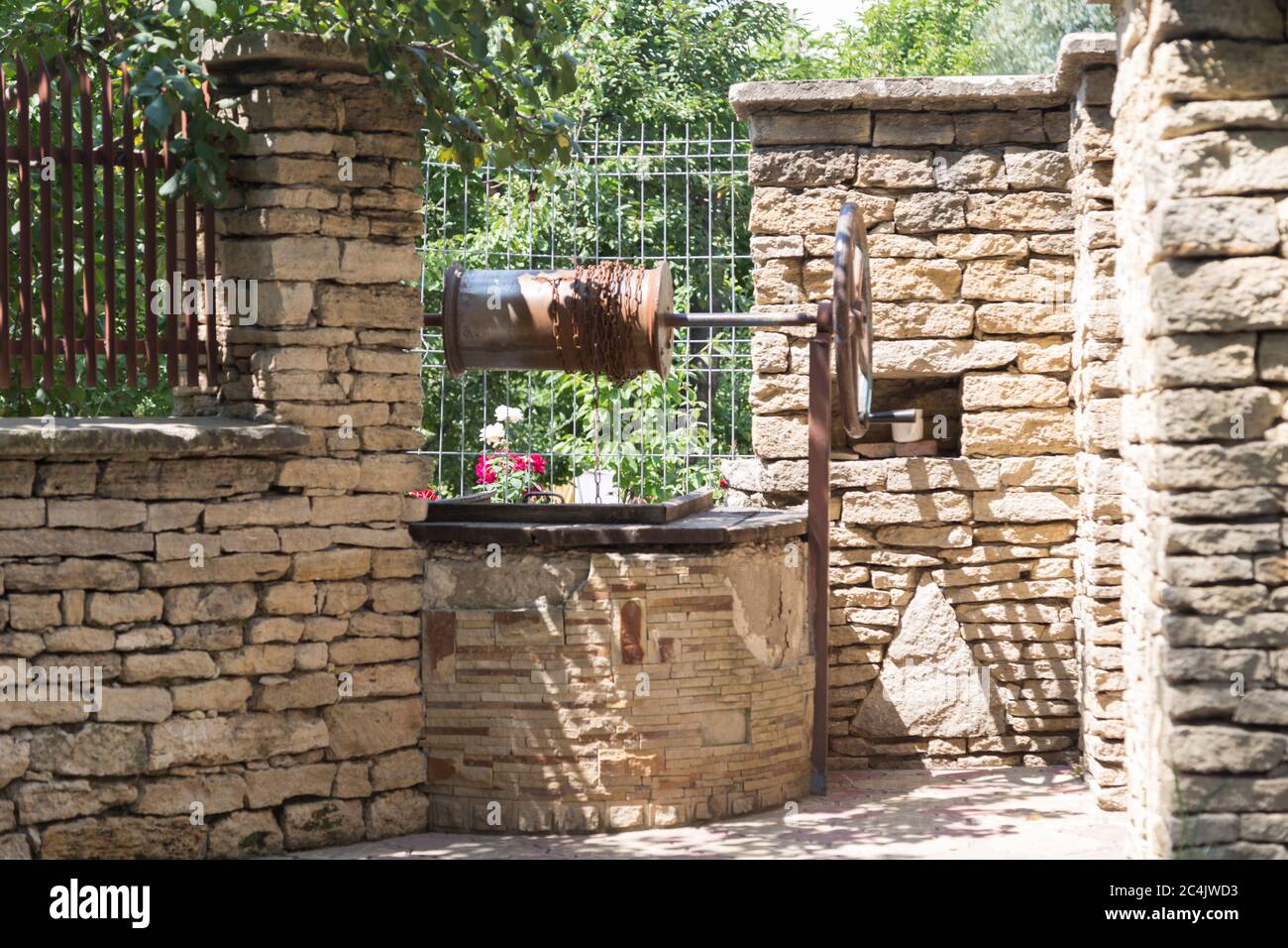 Traditional draw well in the street of a village. The well is made of ...