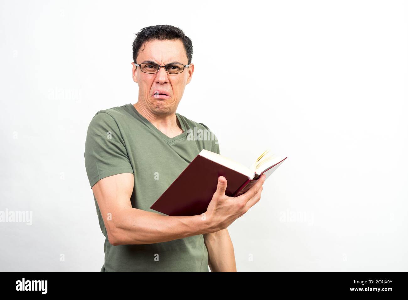 Man reading something that is surprising him a lot in a book. Mid shot ...