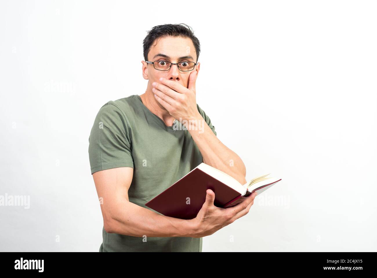 Man reading something that is surprising him a lot in a book. Mid shot ...