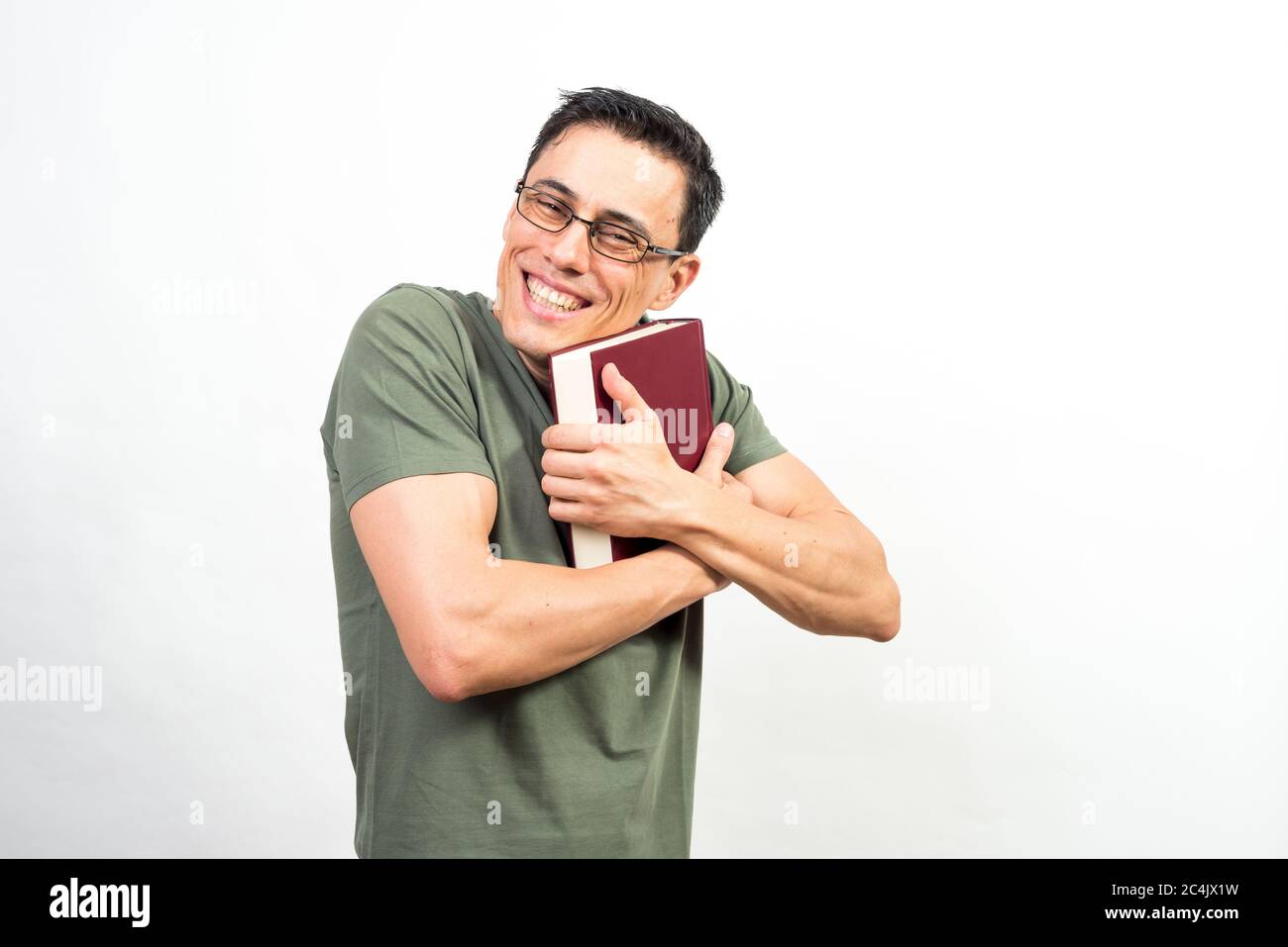 Man with glasses in love with reading hugging a book. Mid shot. White ...