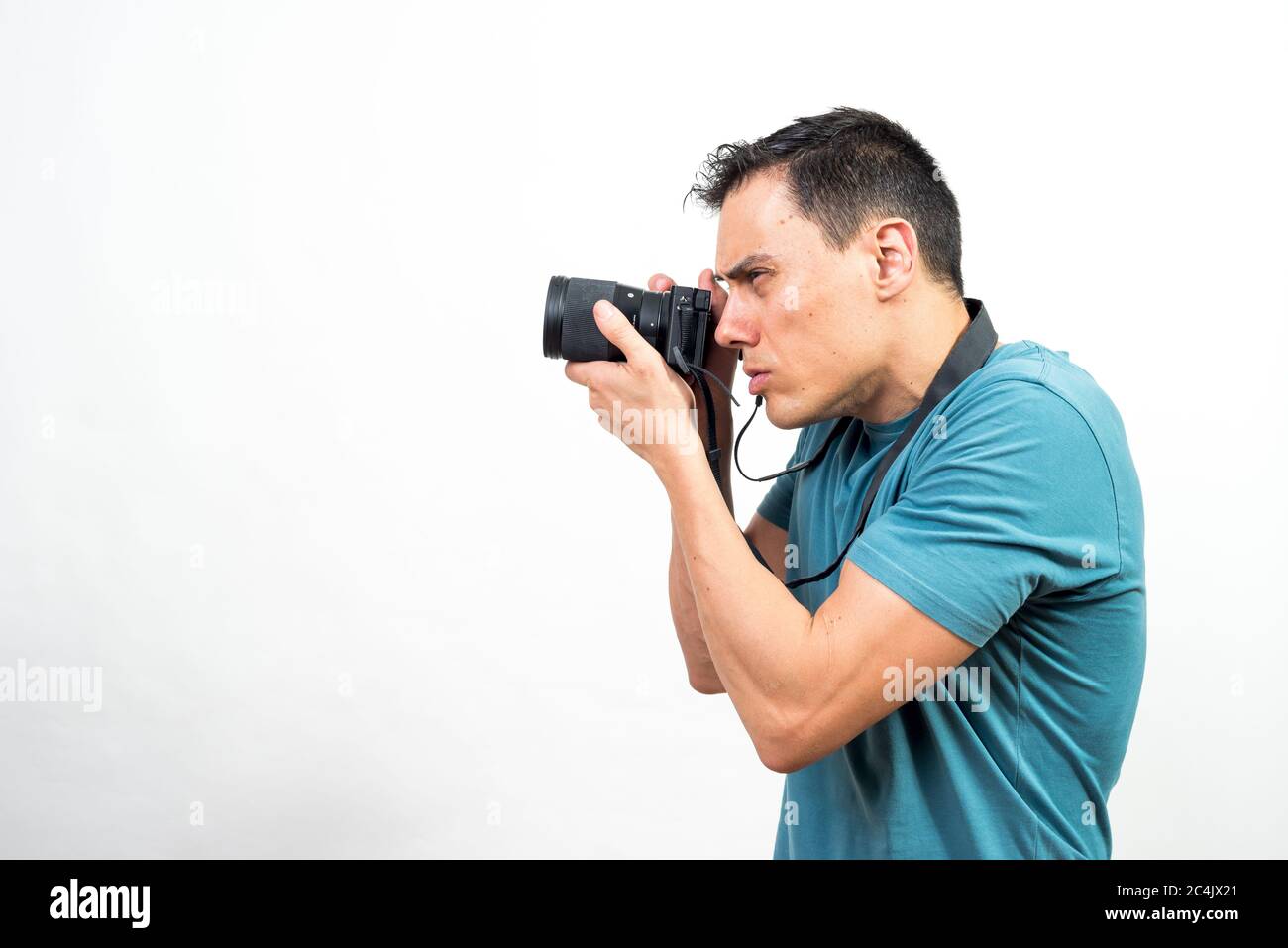 Man with photo camera photographing something very concentrated, side ...