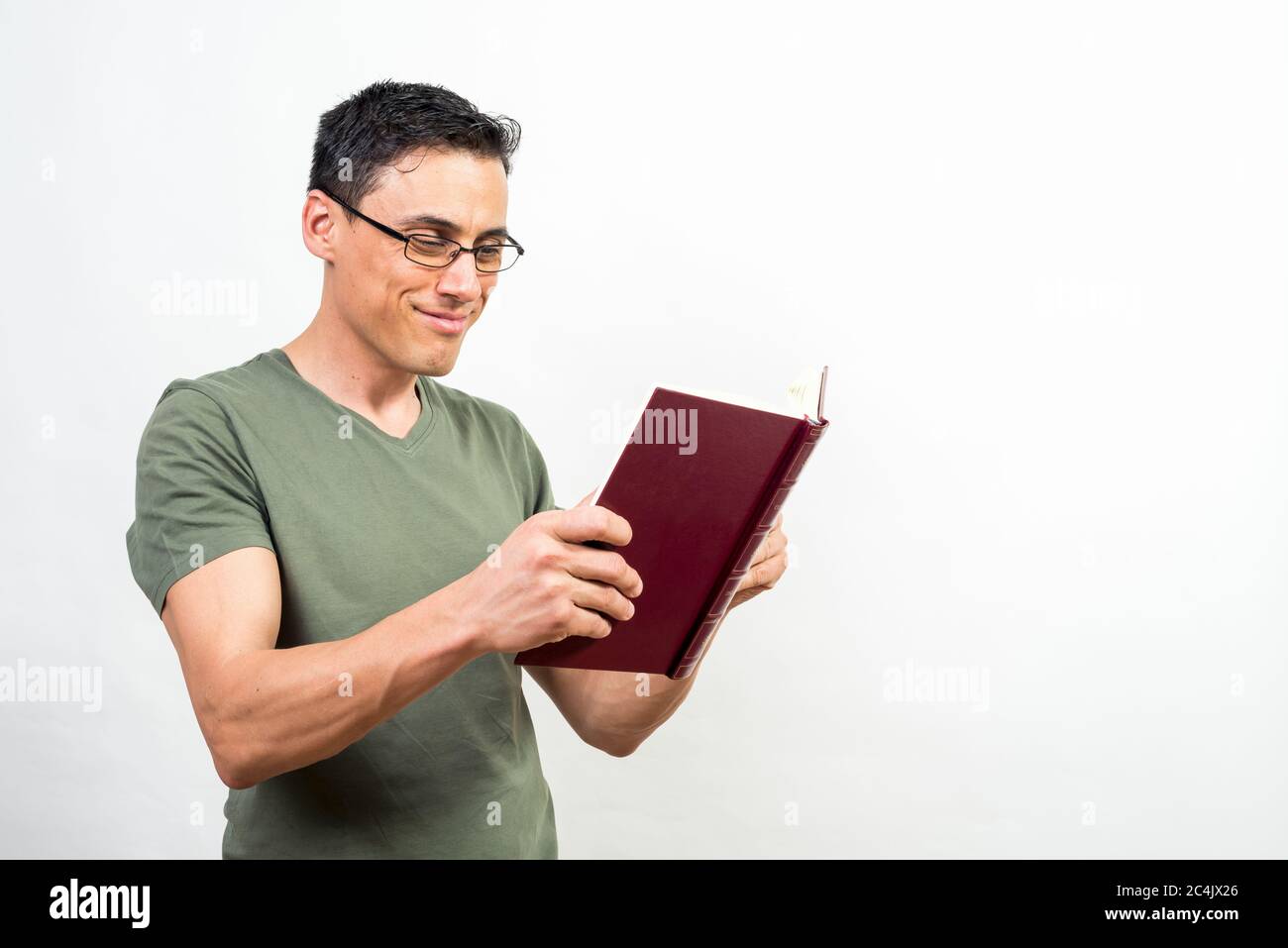 Smiling man with glasses reading a book. Mid shot. White background ...