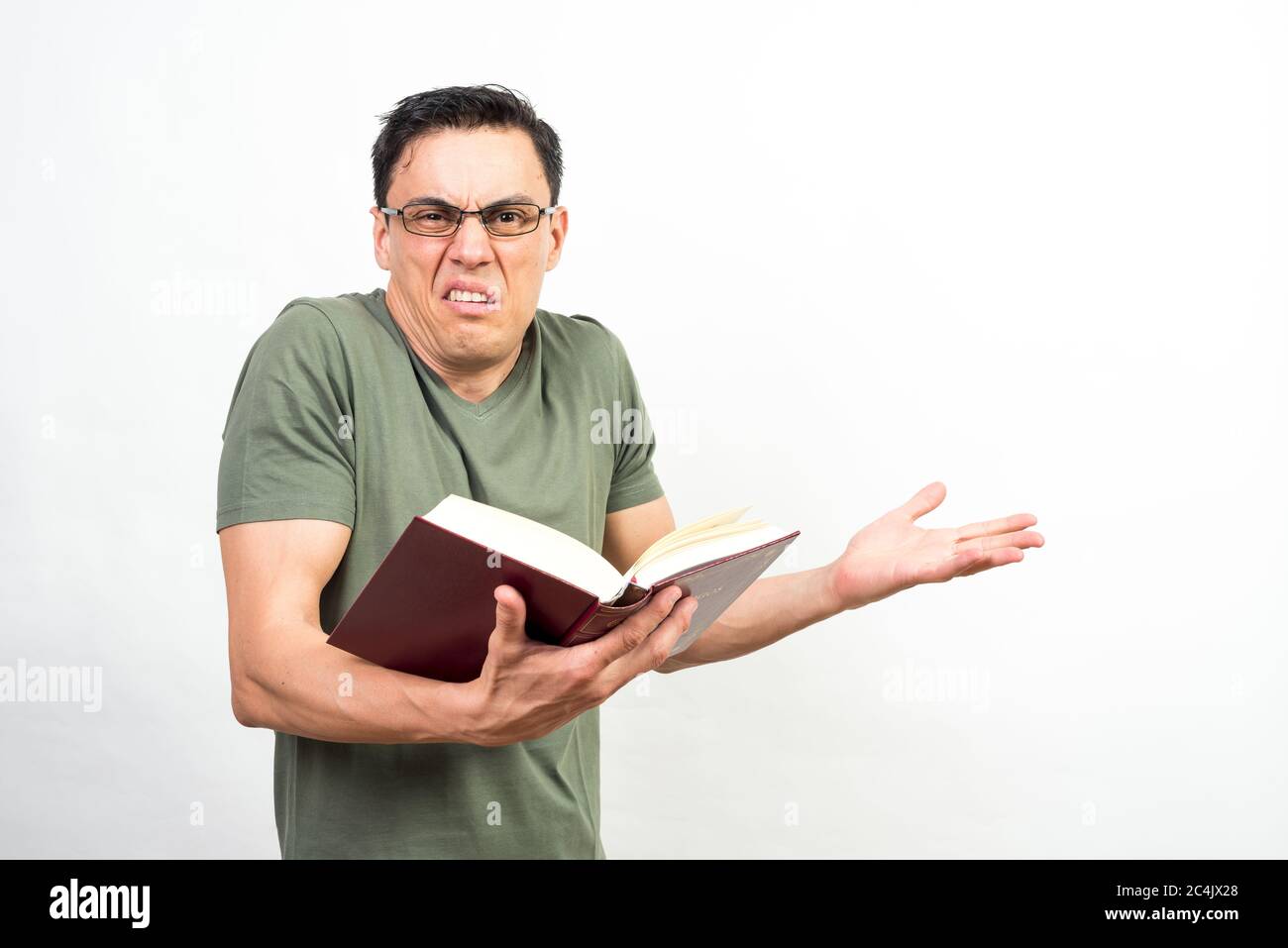 Man reading something that is surprising him a lot in a book. Mid shot ...