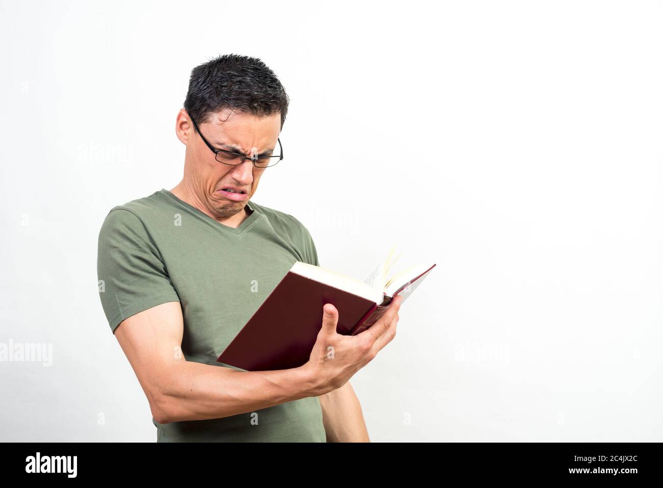 Man reading something that is surprising him a lot in a book. Mid shot ...